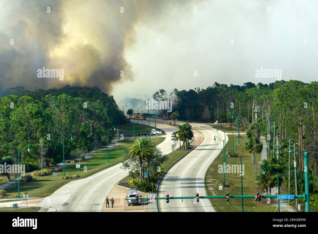 Emergency service firetrucks extinguishing wildfire burning in Florida ...