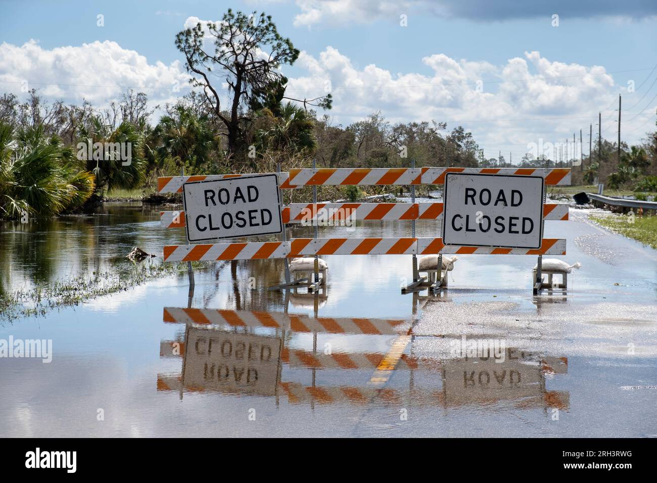 Flooded street in Florida after hurricane rainfall with road closed ...