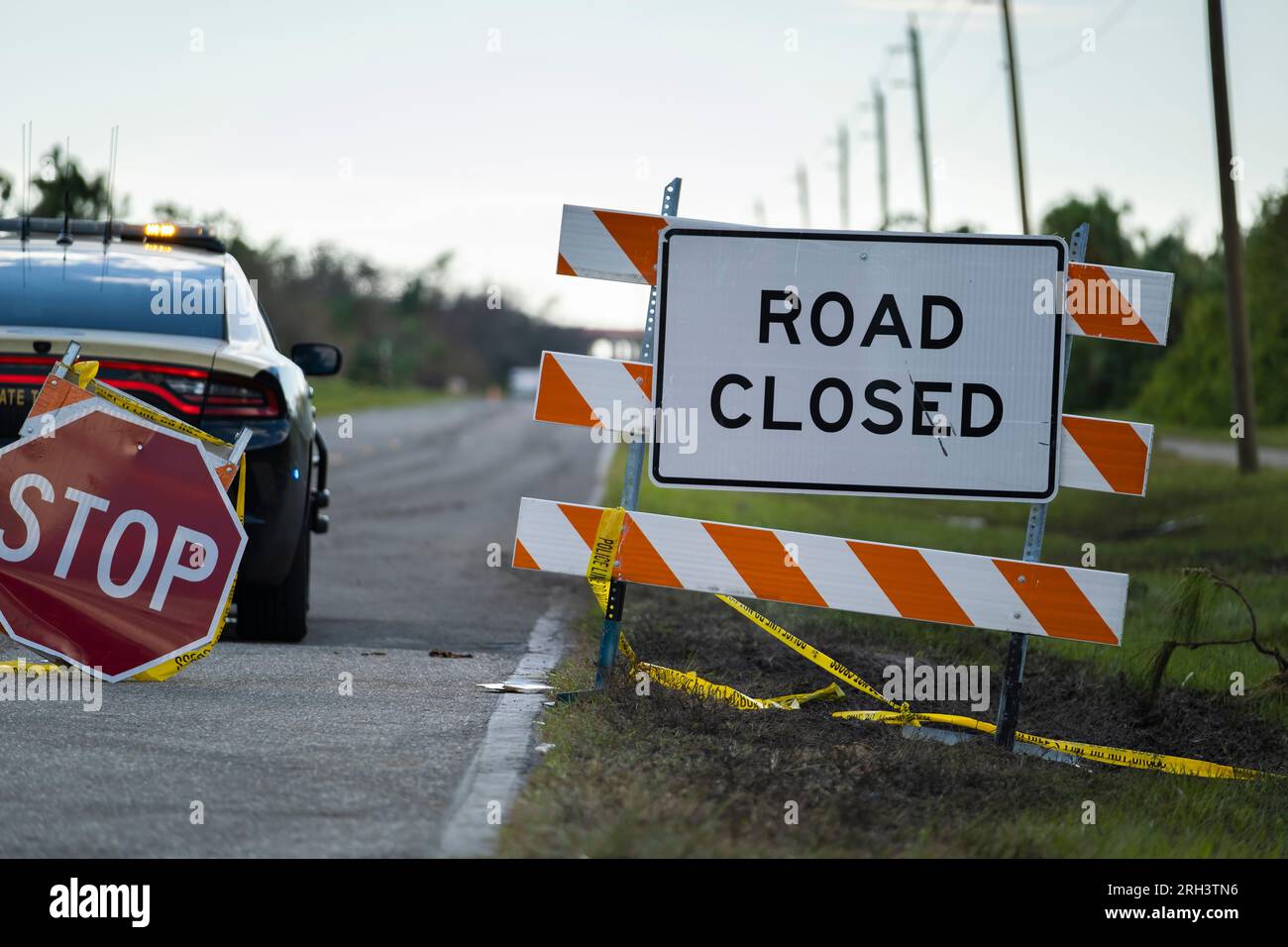 Police patrol car at yellow protective barrier at street construction ...