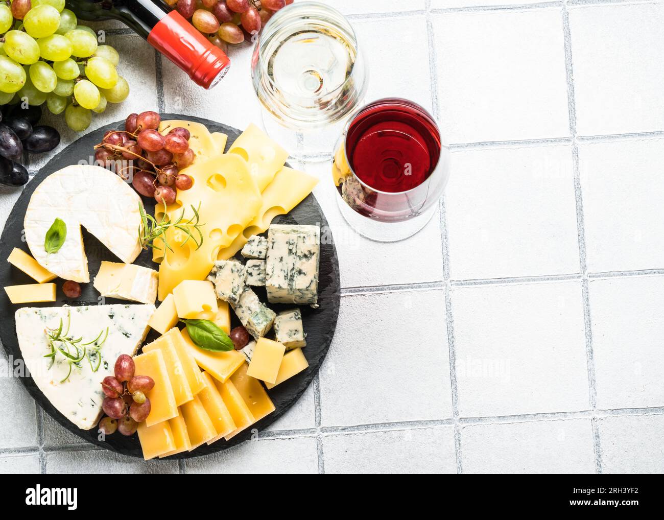 Cheese platter with craft cheese assortment on slate board at white ...