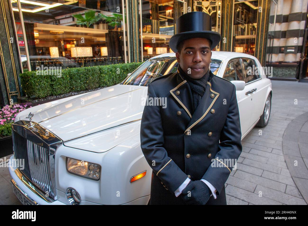 Door man standing in front of white Rolls-Royce at the Savoy Hotel in ...