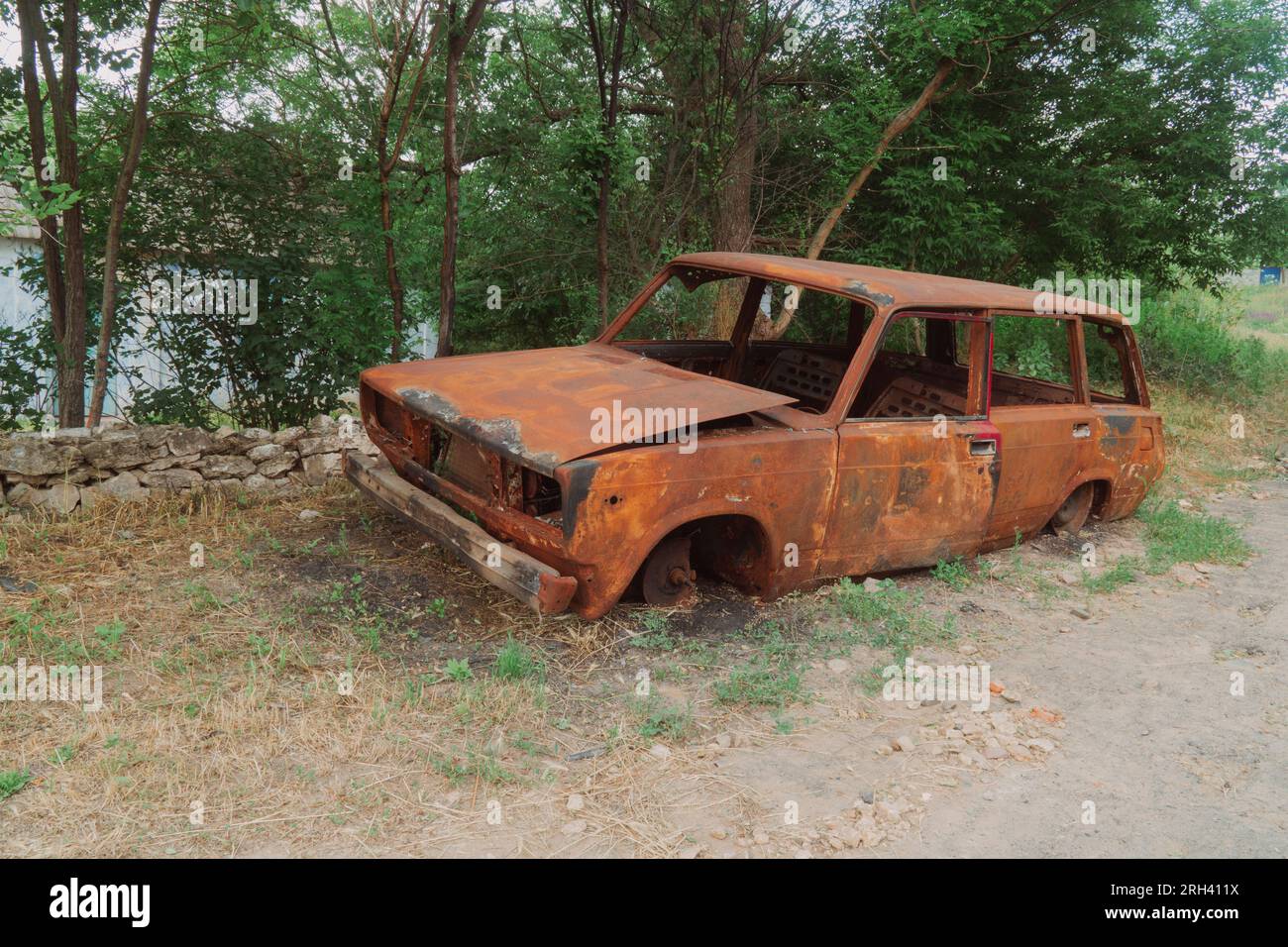 Countryside. On the side of the road is a destroyed, burned-out ...