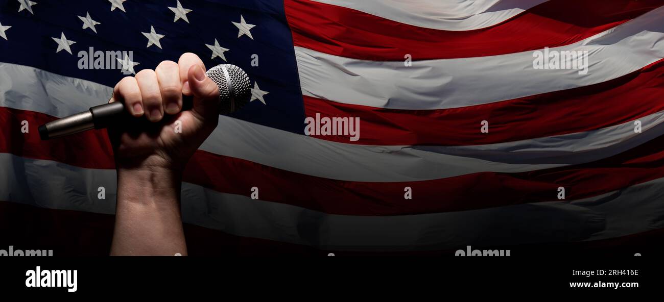 Male Fist Gripping Microphone Over Waving American Flag Background ...
