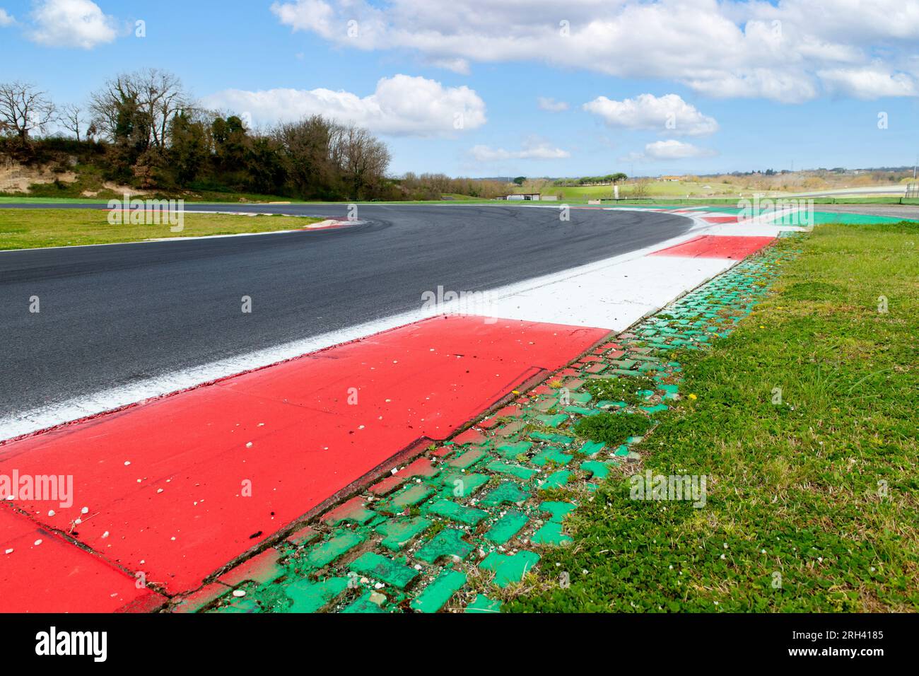 Motor sport asphalt race track and curbs with skid marks, low angle ...