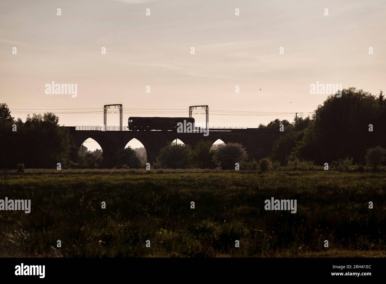Sillhouette of a DB Cargo rail UK class 66 locomotive (66063) crossing ...
