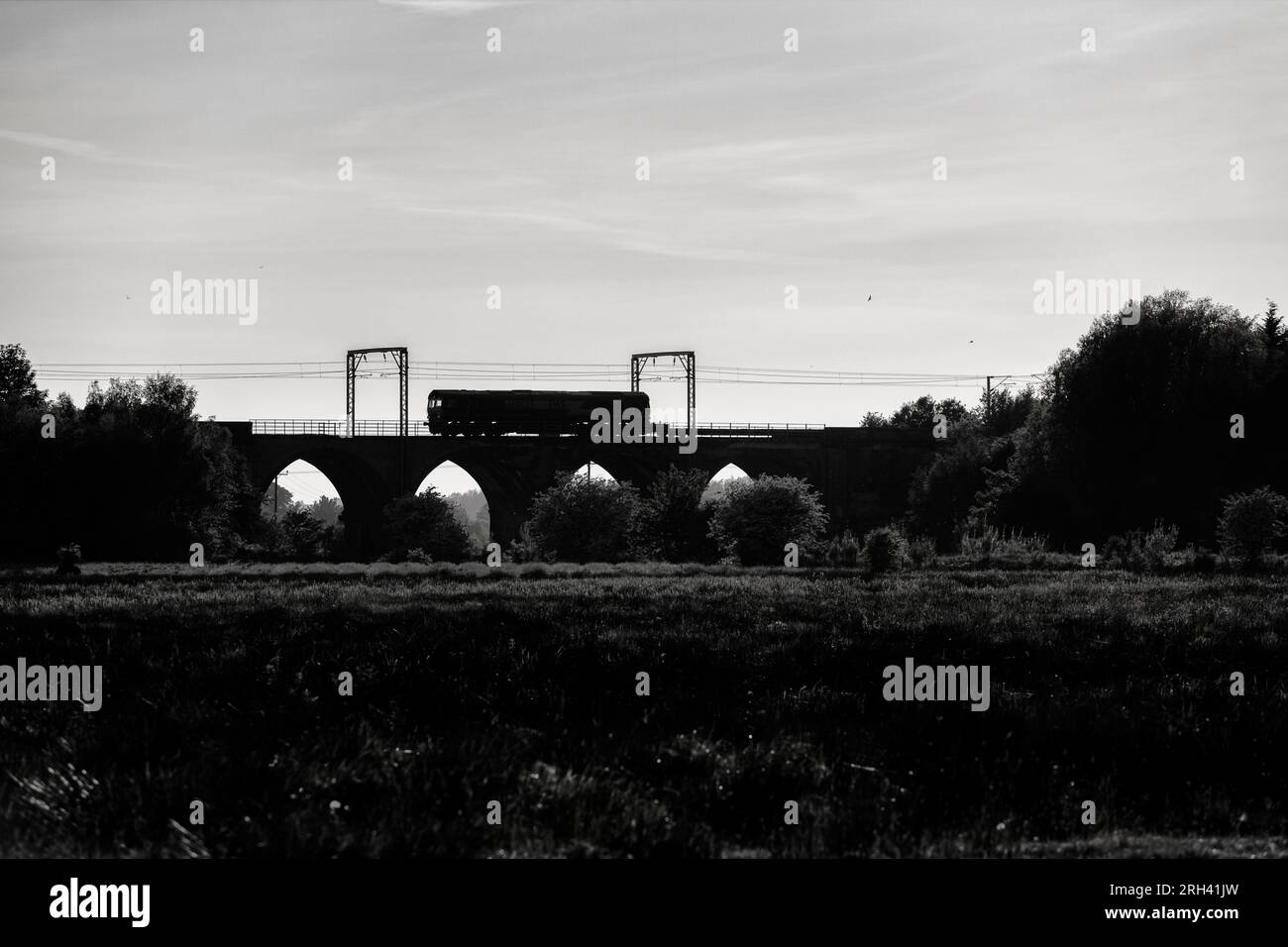 Sillhouette of a DB Cargo rail UK class 66 locomotive (66063) crossing ...