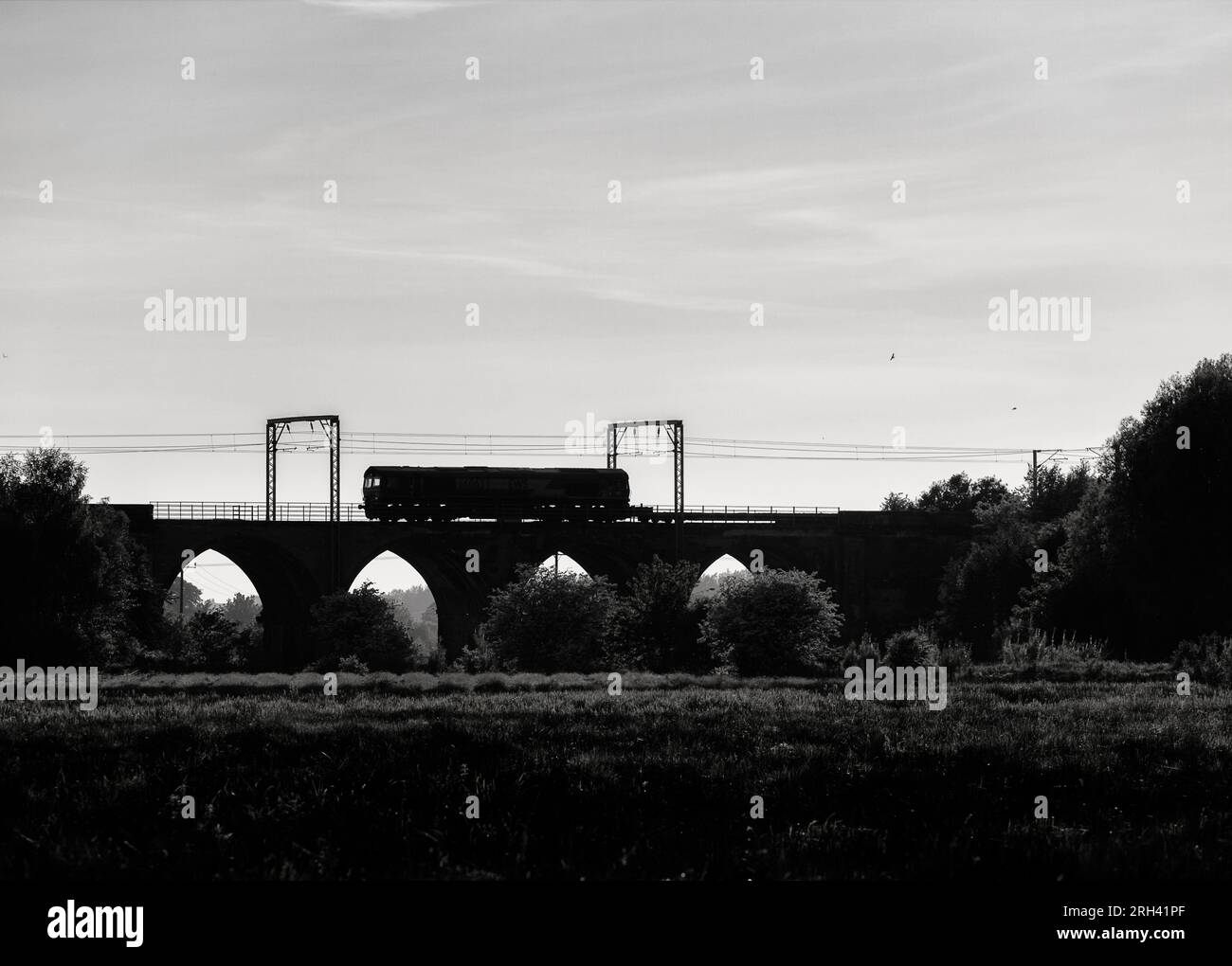 Sillhouette of a DB Cargo rail UK class 66 locomotive (66063) crossing ...