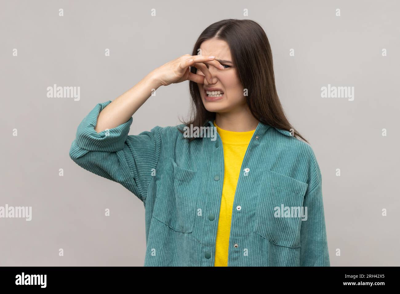 Woman pinching nose, stop breathing bad odor, disgusted by smell of ...