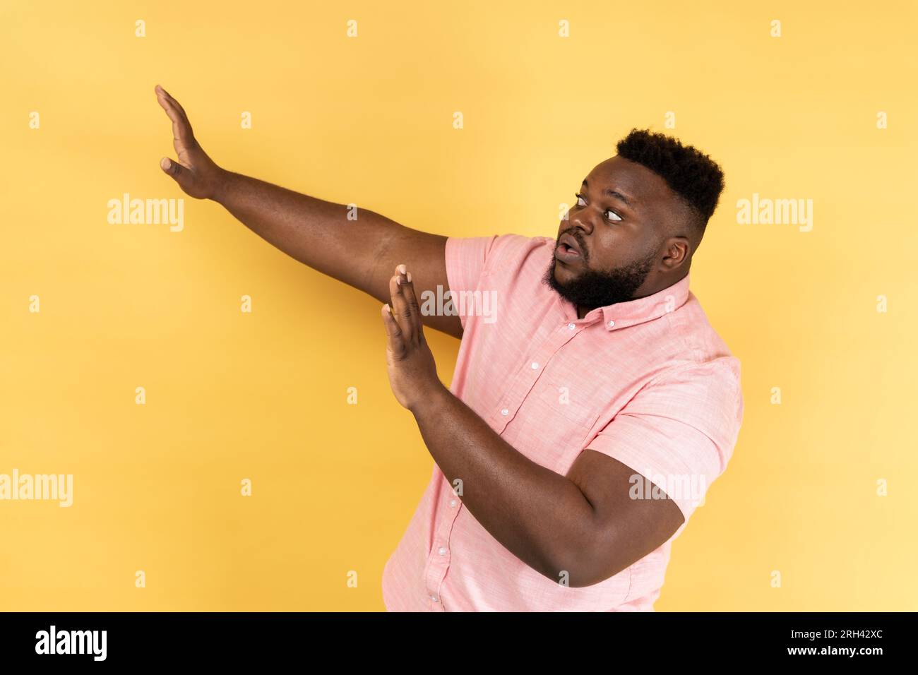 No, it's scary. Side view of frightened shocked man wearing pink shirt ...