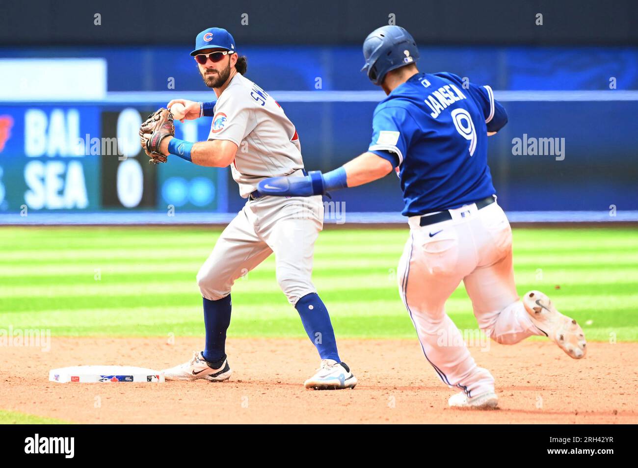 Chicago Cubs shortstop Dansby Swanson, left, forces out Toronto Blue ...