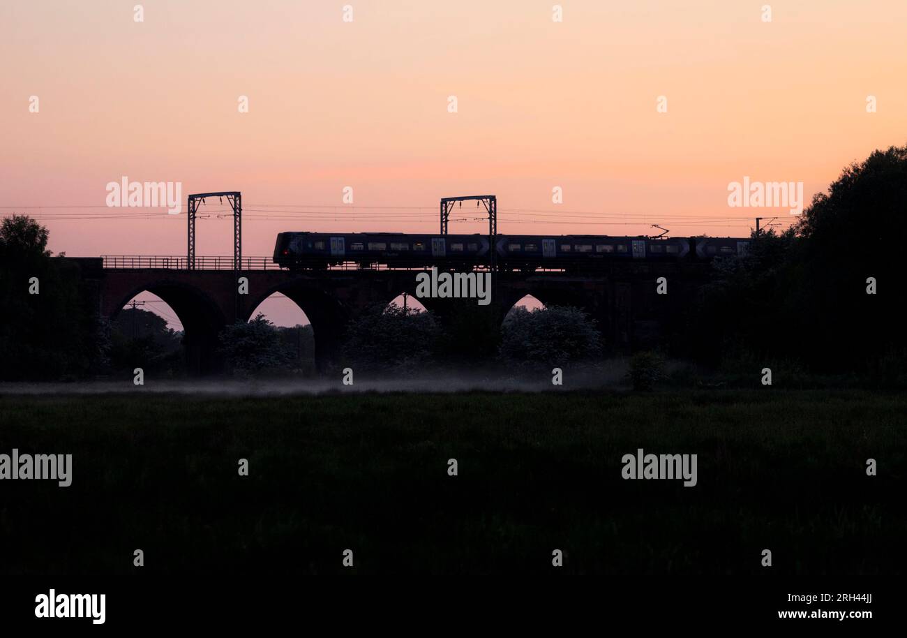 With mist on the a Scotrail class 380 train crosses Garnock Longford ...