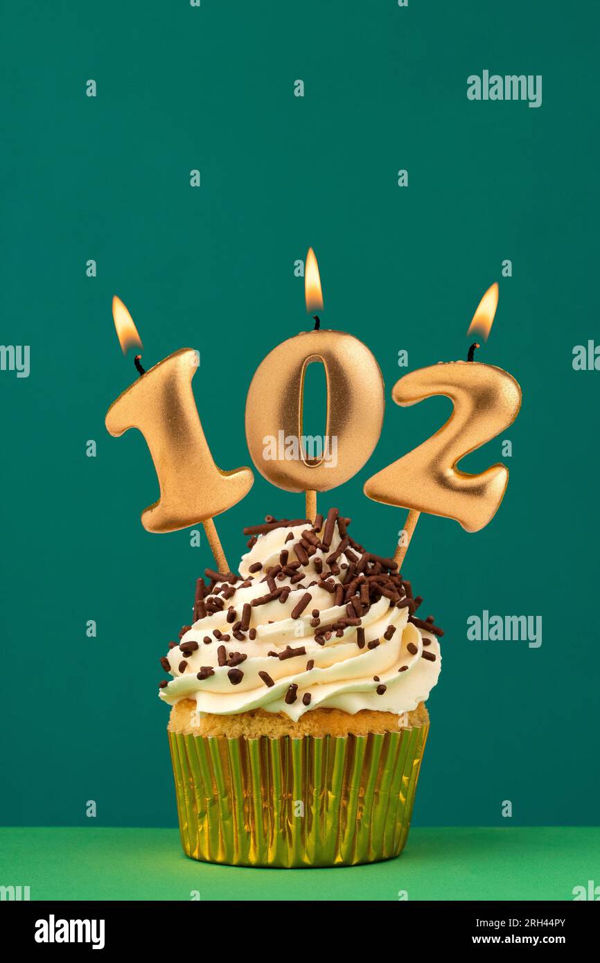Birthday card with candle number 102 - Green background Stock Photo - Alamy