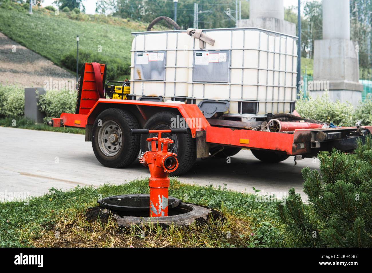 fire hydrant on the background of a trailer in water tanks for watering ...