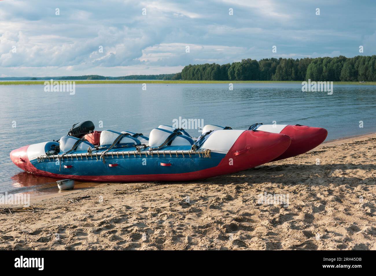 inflatable raft-catamaran for whitewater sports is moored on the lake ...