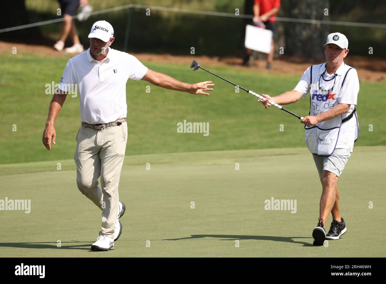 MEMPHIS, TN - AUGUST 13: Lucas Glover gets his putter from his caddie ...