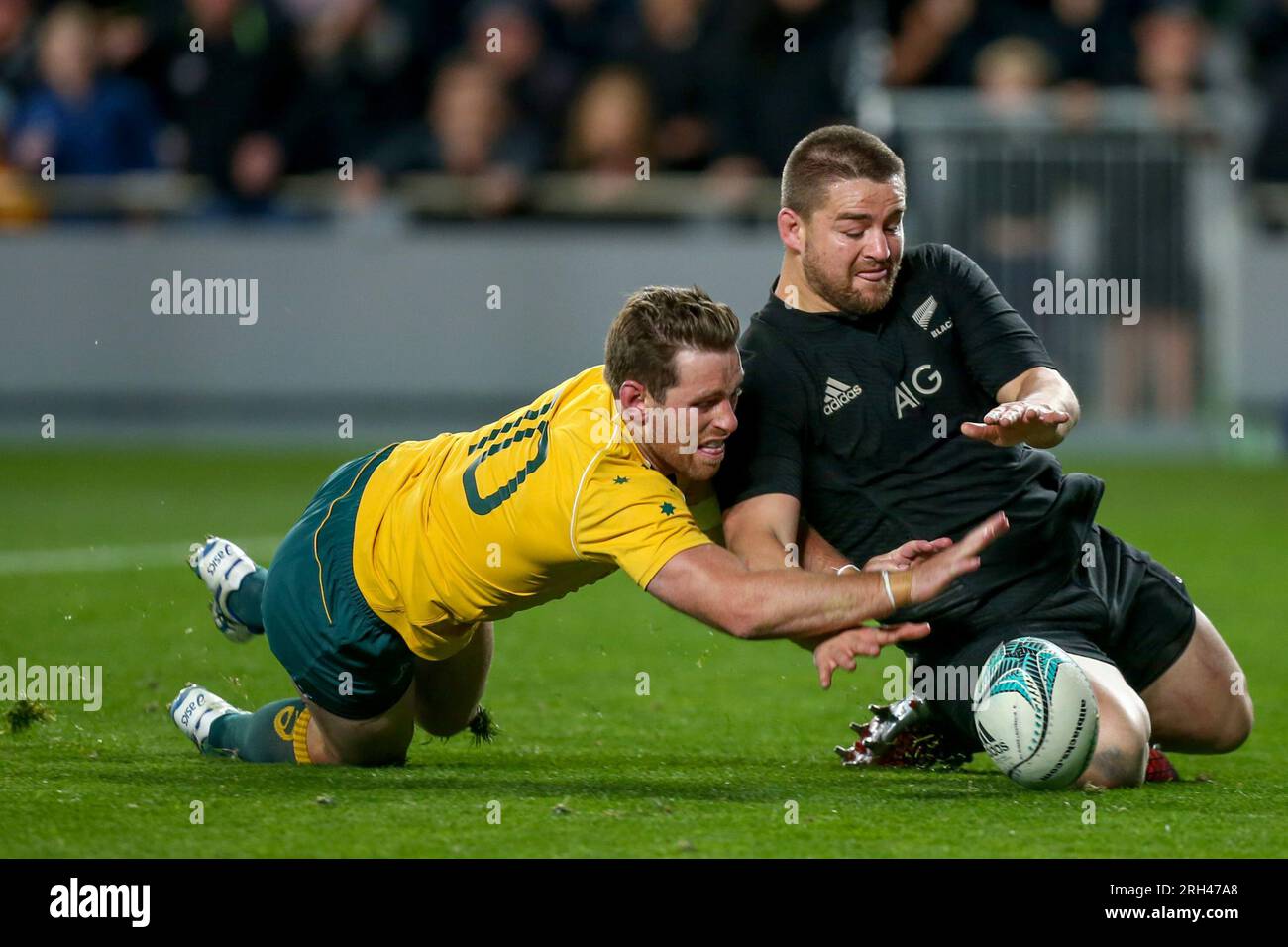 Bernard Foley of Australia prevents Dane Coles of New Zealand from ...
