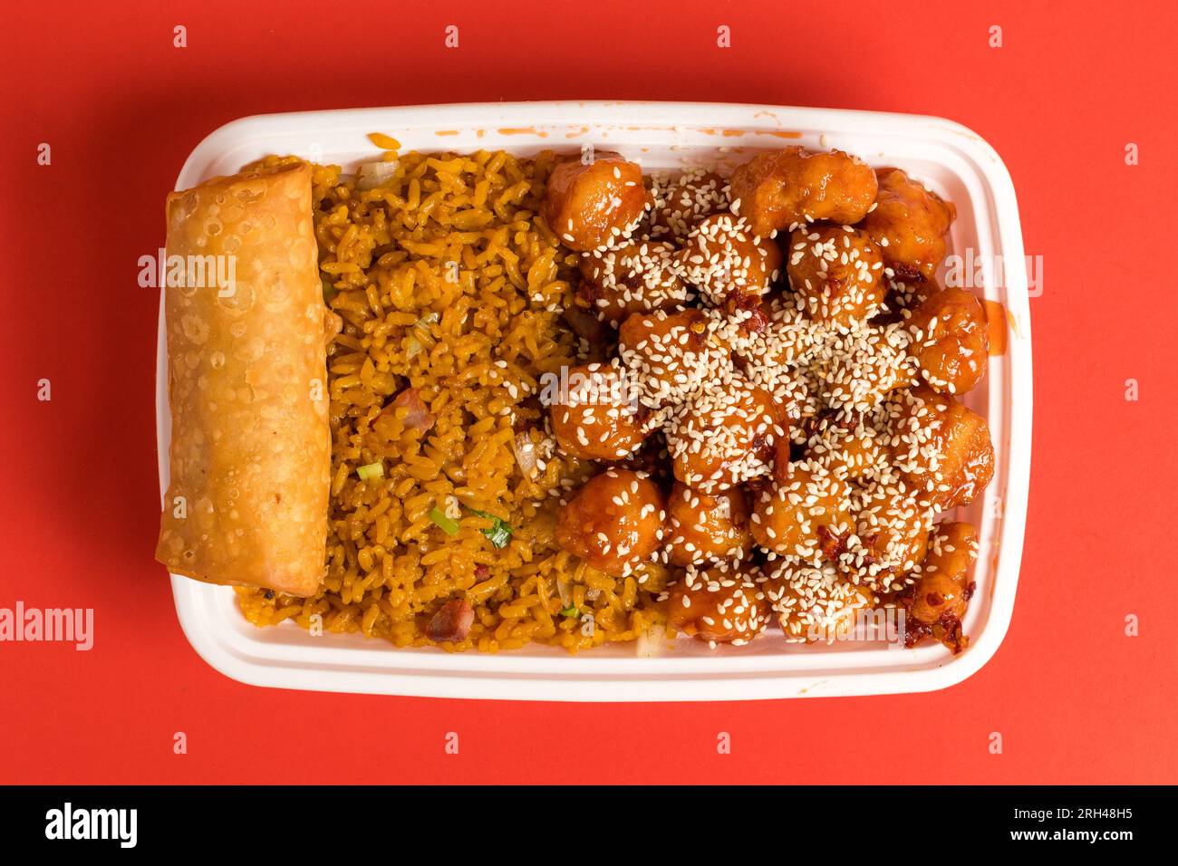 Sesame chicken with fried rice and egg roll Stock Photo - Alamy