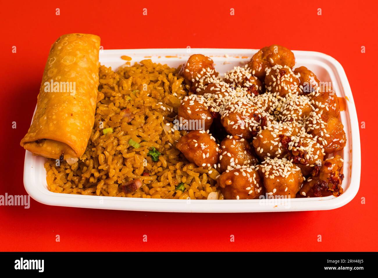 Sesame chicken with fried rice and egg roll Stock Photo - Alamy