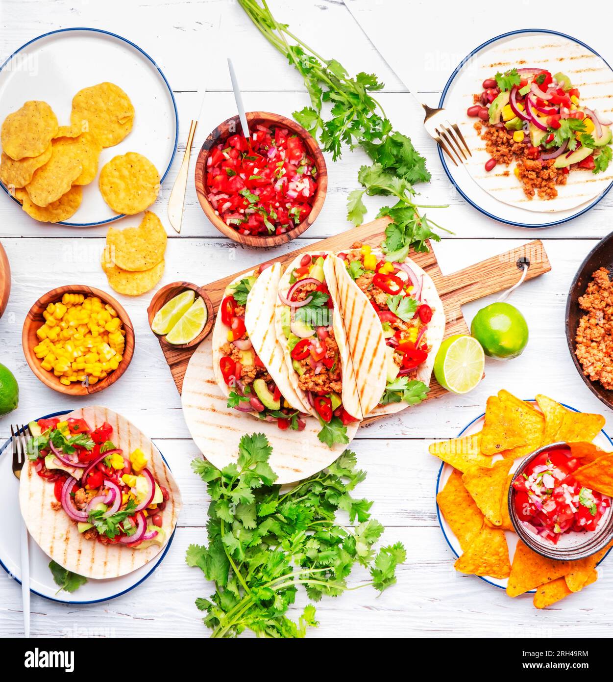 Taco party. Served table with tortillas, nachos, sauces, appetizers and ...