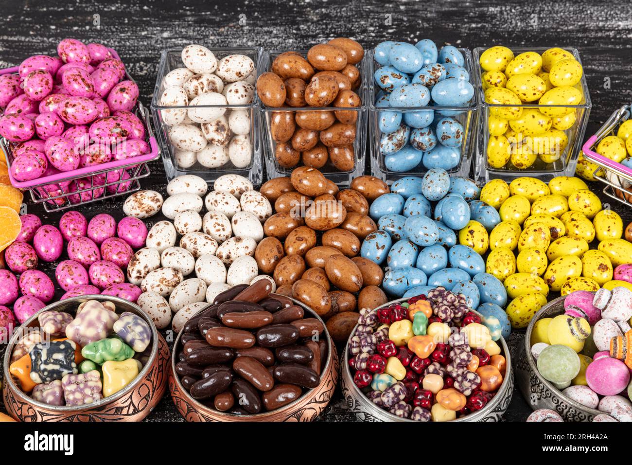 Heap of sugared almonds and hazelnuts dragees in chocolate isolated on ...