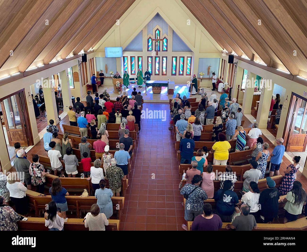 Parishioners attend Mass at Sacred Hearts Mission Church in Kapalua, Hawaii, Sunday, Aug. 13 ...