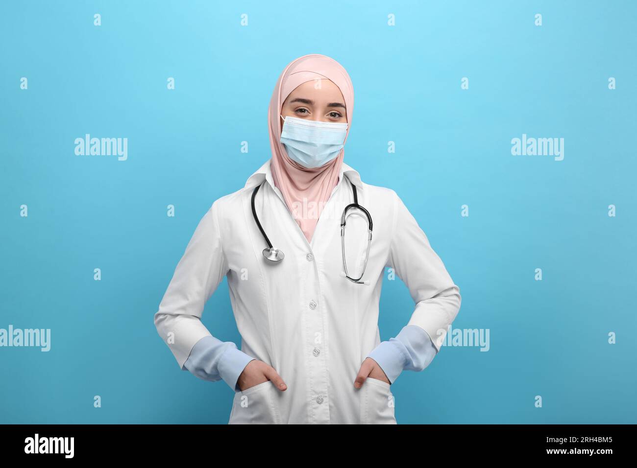 Muslim woman wearing hijab, medical uniform and protective mask on ...