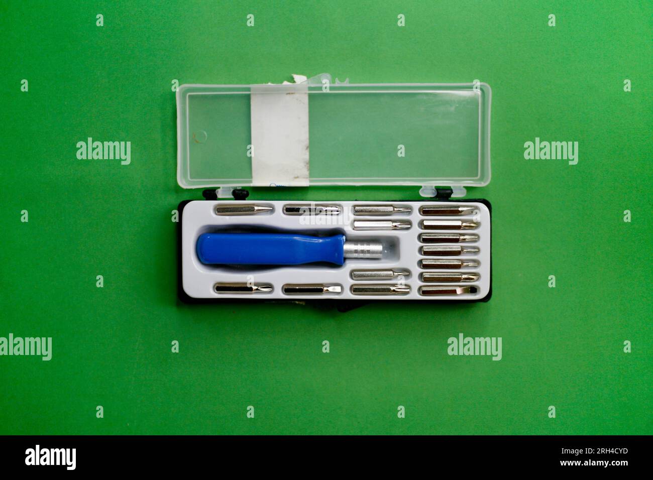 Screwdriver set with nozzles in a plastic box isolated on green ...