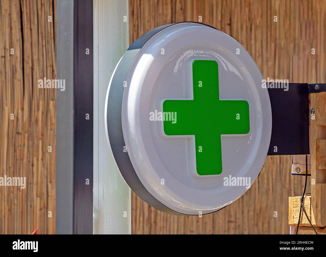 Pharmacy green cross sign attached on a building facade on street Stock ...