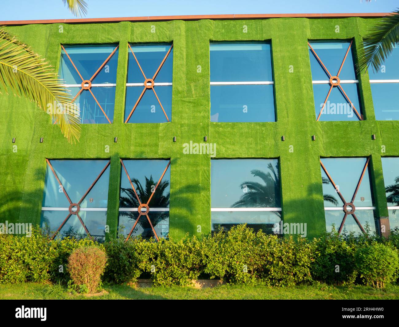 Facade of the building in green matter. Preparations for decorative ...
