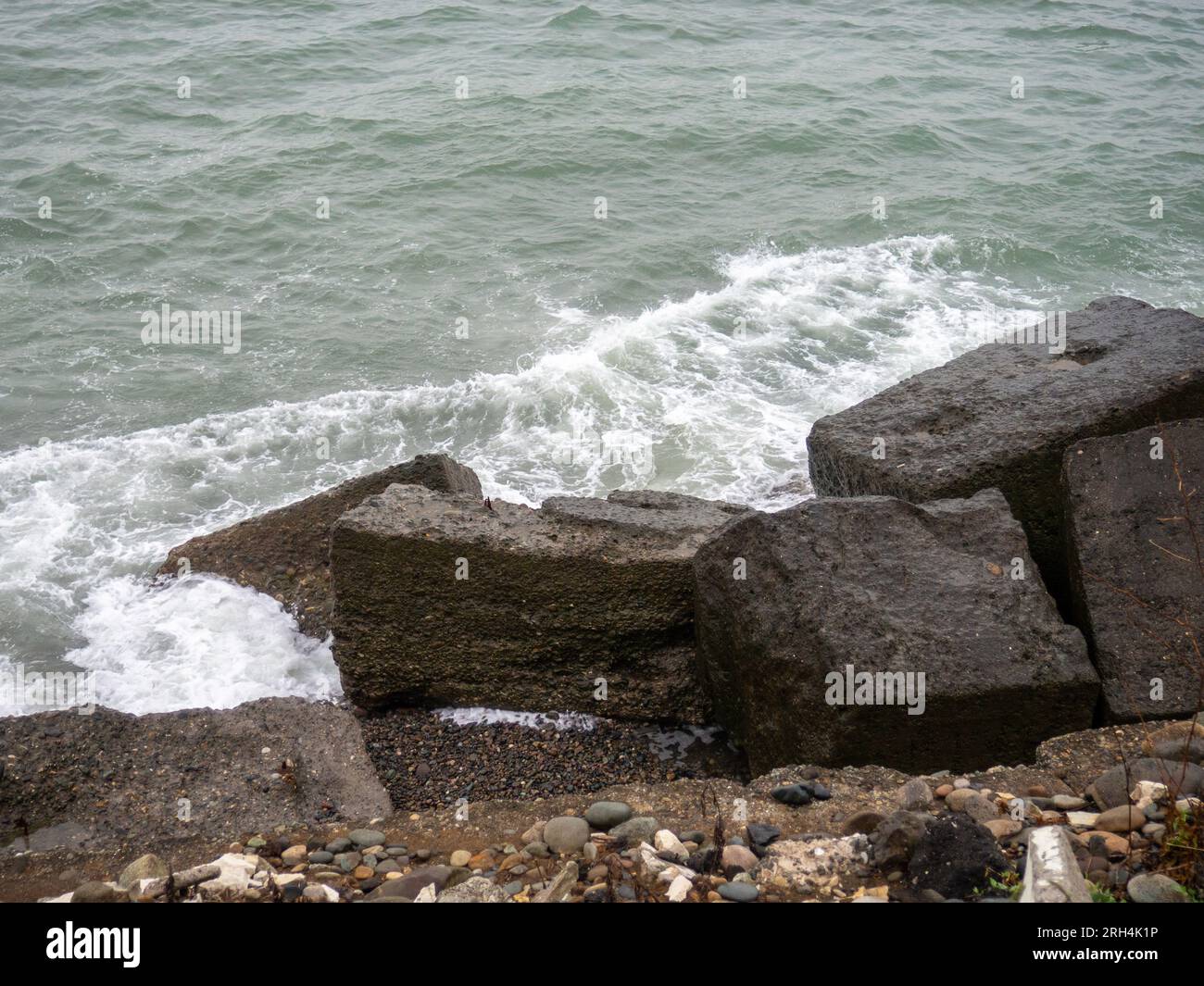 Old blocks of fortifications of the coast. Concrete structures on the ...