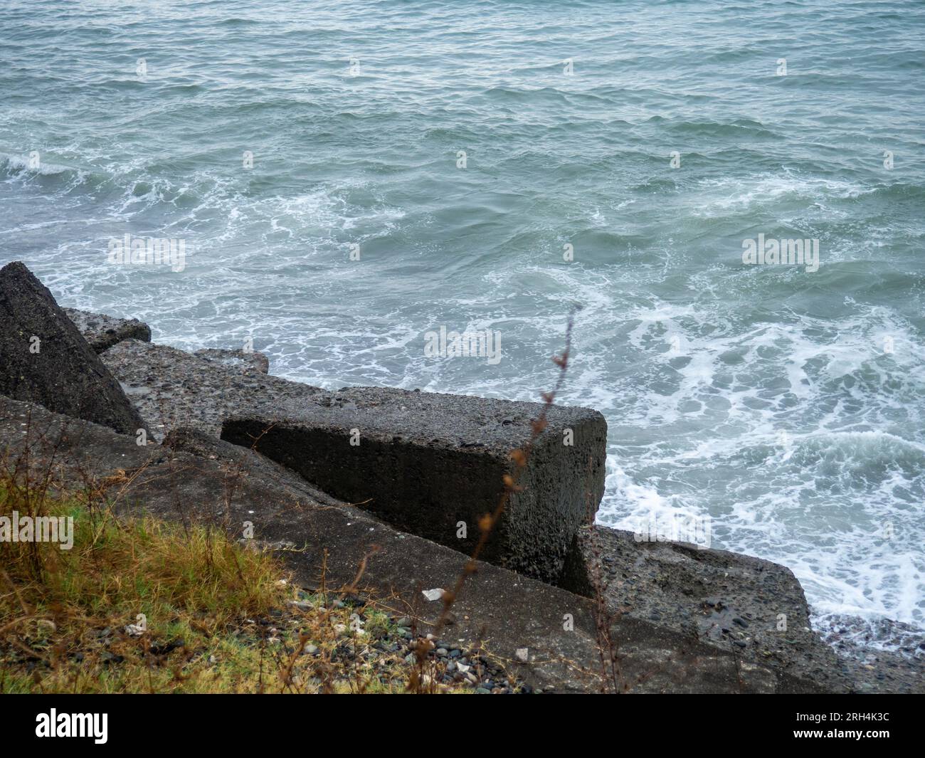 Old blocks of fortifications of the coast. Concrete structures on the ...