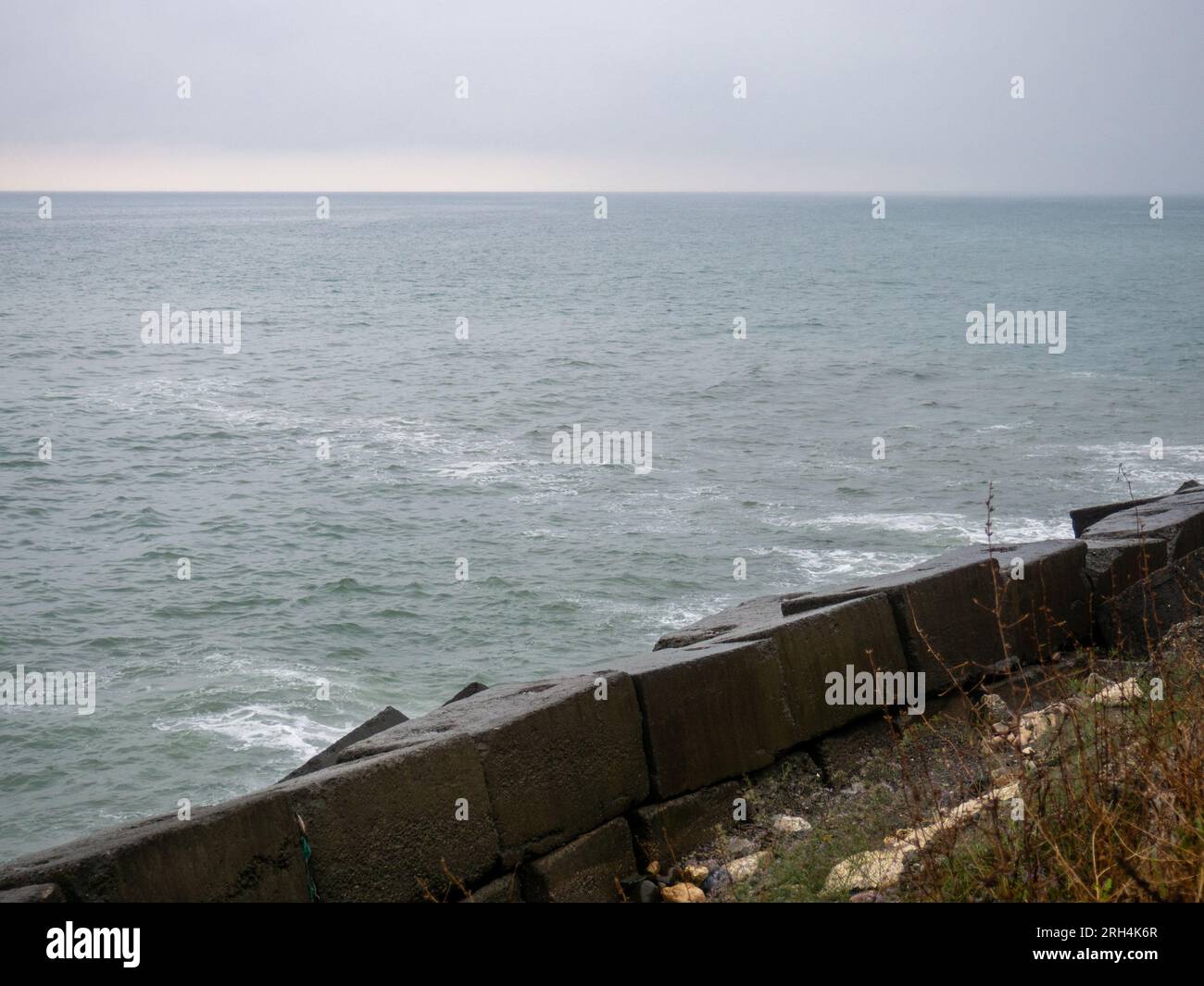 Old blocks of fortifications of the coast. Concrete structures on the ...