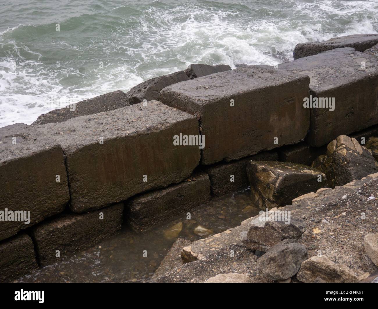 Old blocks of fortifications of the coast. Concrete structures on the ...