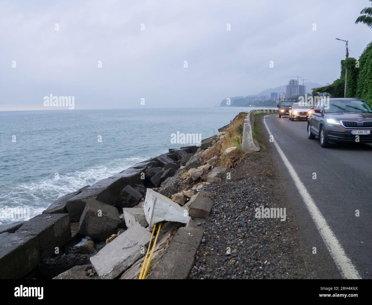 Dangerous place. Collapsed road barrier on a mountainside. Old blocks ...