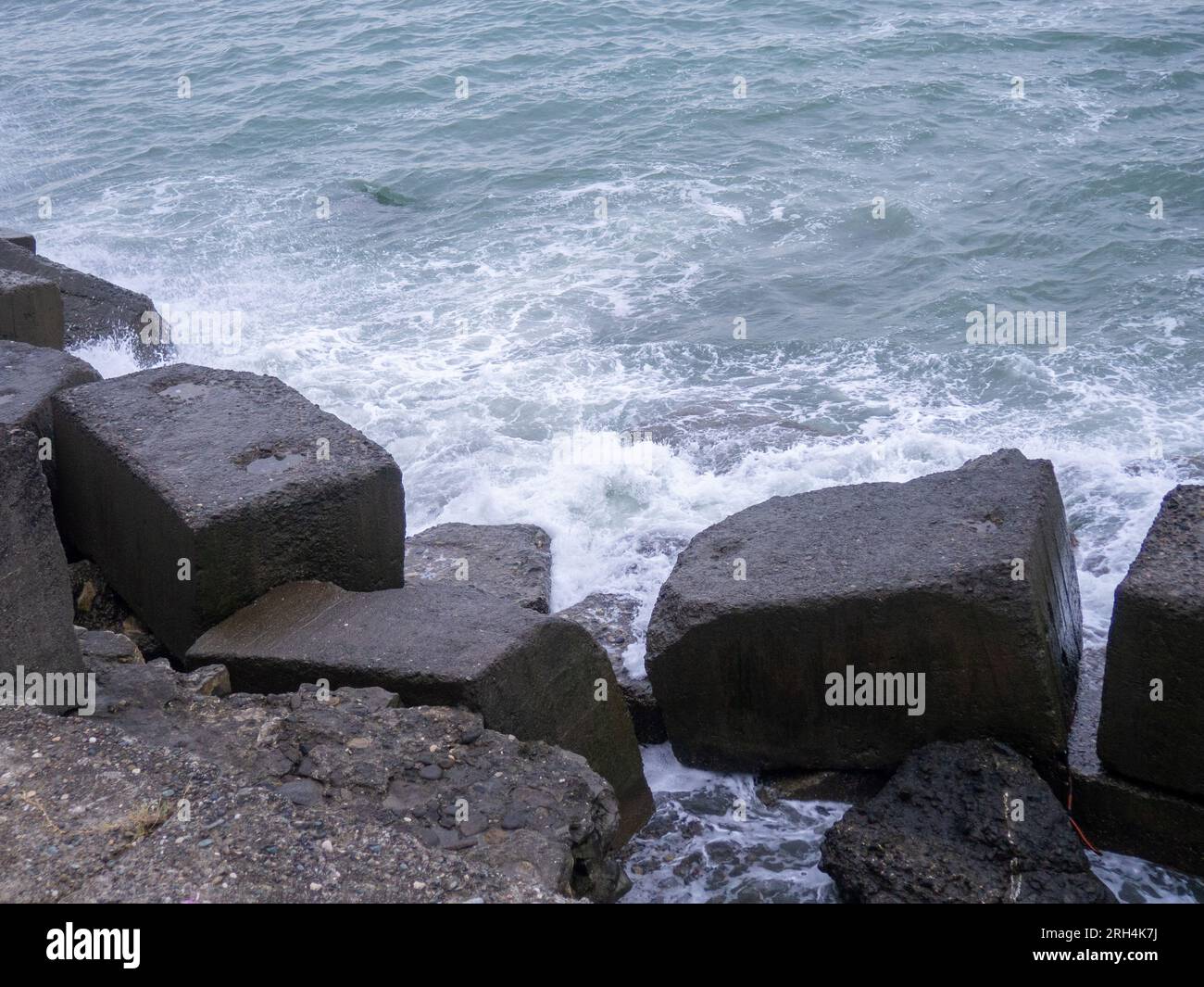 Old blocks of fortifications of the coast. Concrete structures on the ...