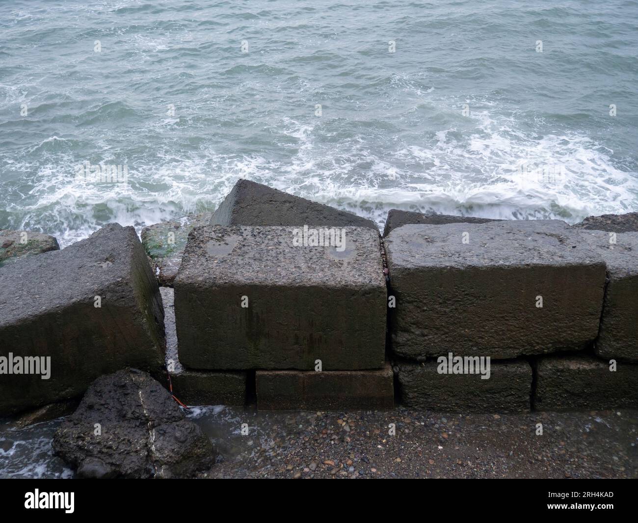 Old blocks of fortifications of the coast. Concrete structures on the ...
