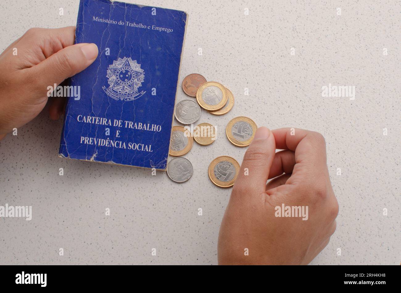 Brazilian work card displayed with money from Brazil, representing the ...