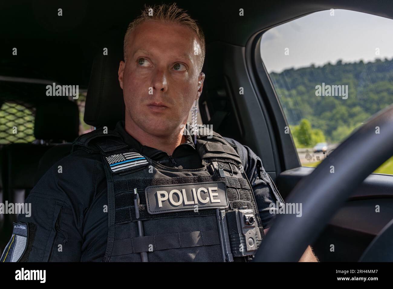 Patience in blue: Officer's watchful gaze from the cruiser, ever ...