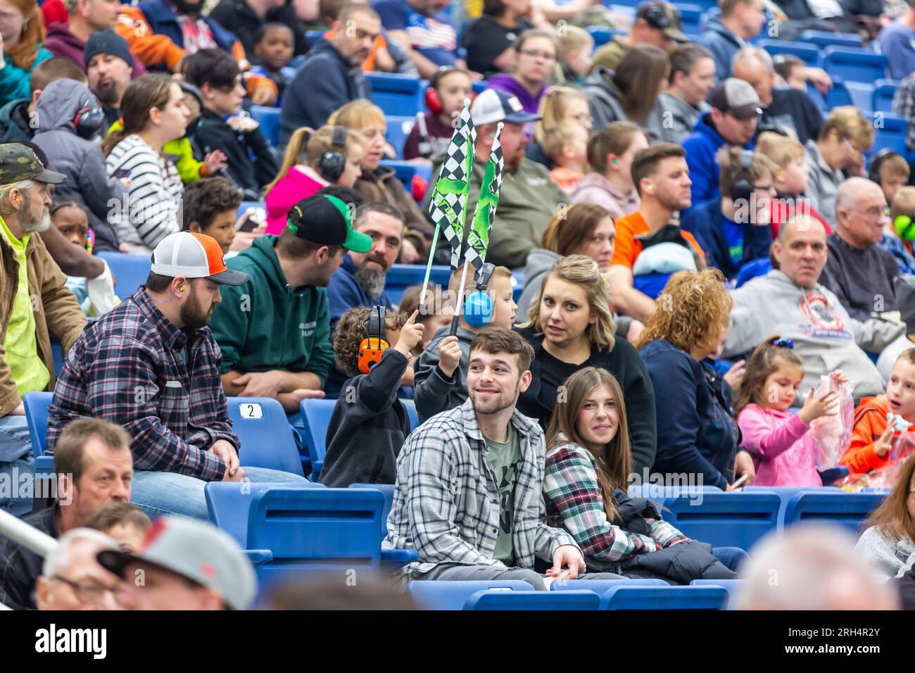 A young boy raises his checkered flags amidst the crowd at the Allen ...