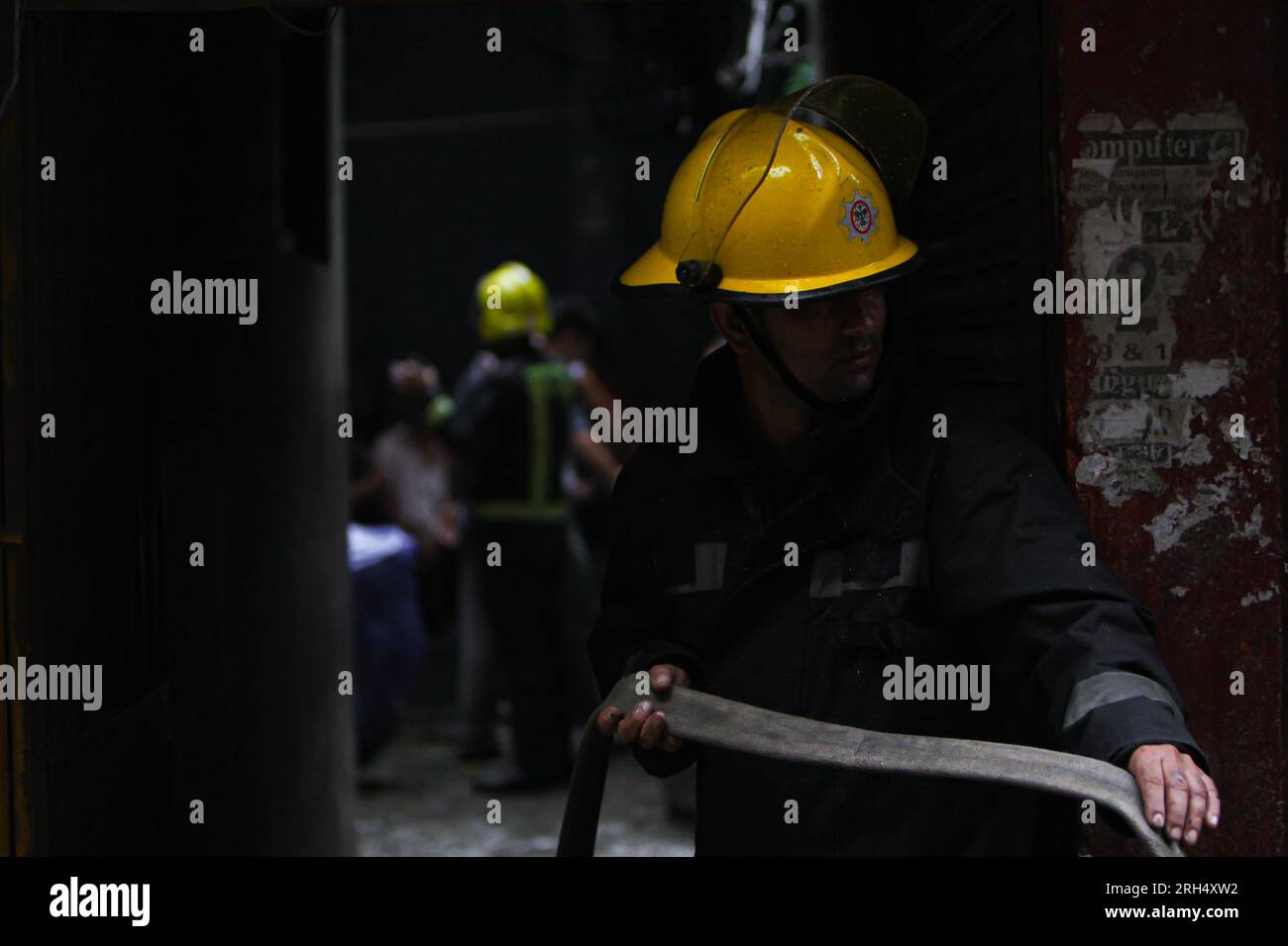 A firefighter personnel wrapped a water pipe after dousing a house fire ...