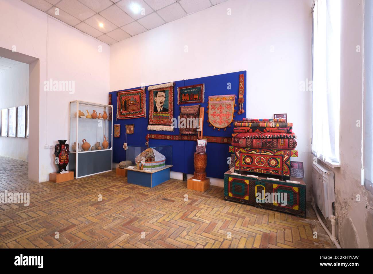 A display of various traditional textiles and a model of a yurt tent ...