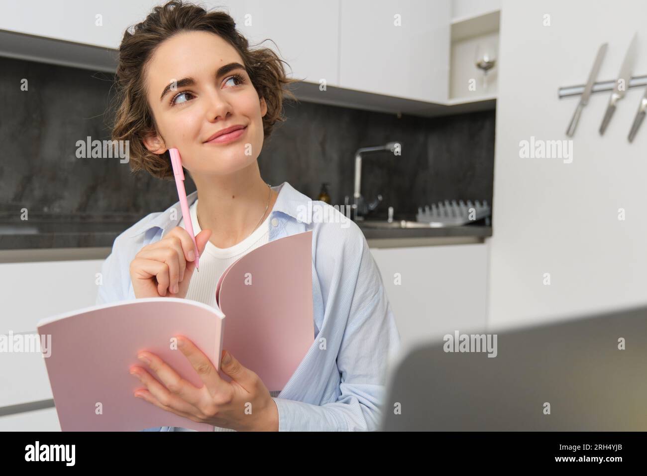 Portrait of young businesswoman, works from home, looks thoughtful ...