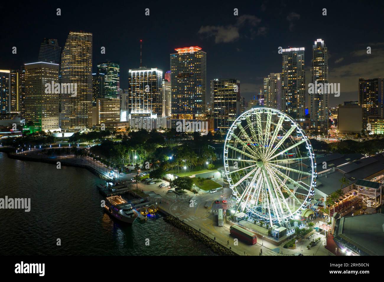 Skyviews Miami Observation Wheel at Bayside Marketplace with reflections in Biscayne Bay water ...