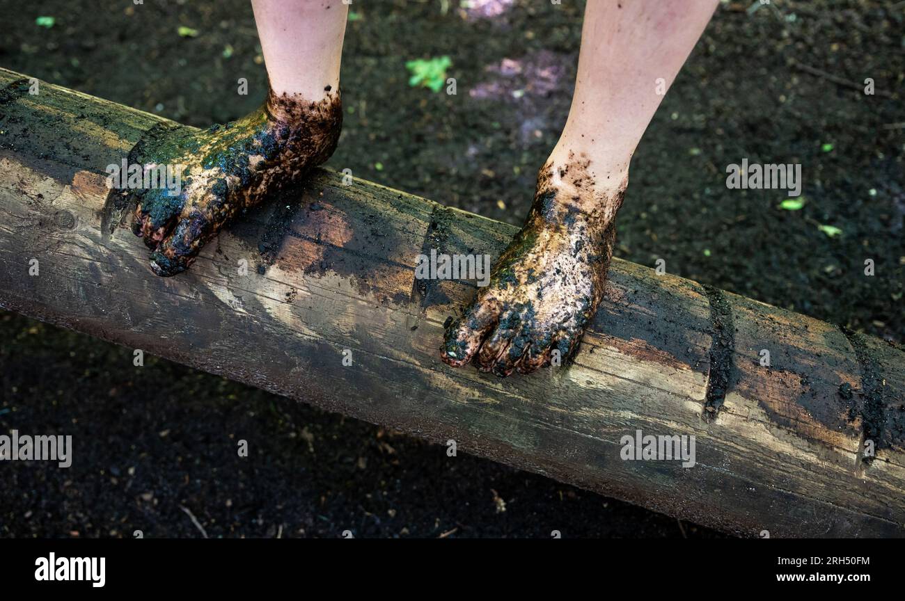 Egestorf, Germany. 10th Aug, 2023. A child's feet are covered in mud at ...