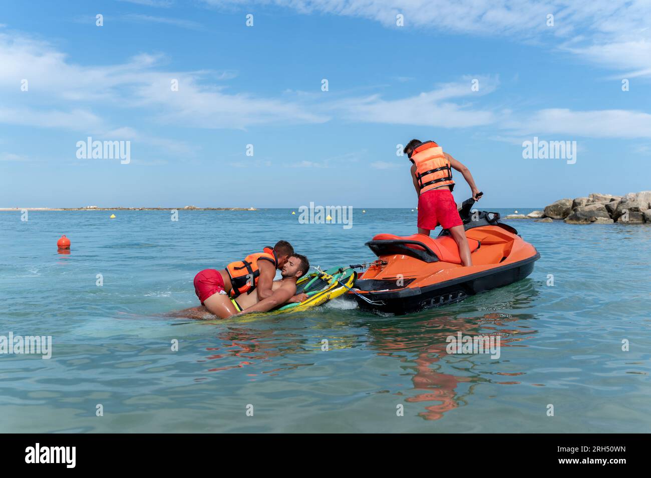 Photo with copy space of Lifeguards rescue a man in the sea using a jet ...
