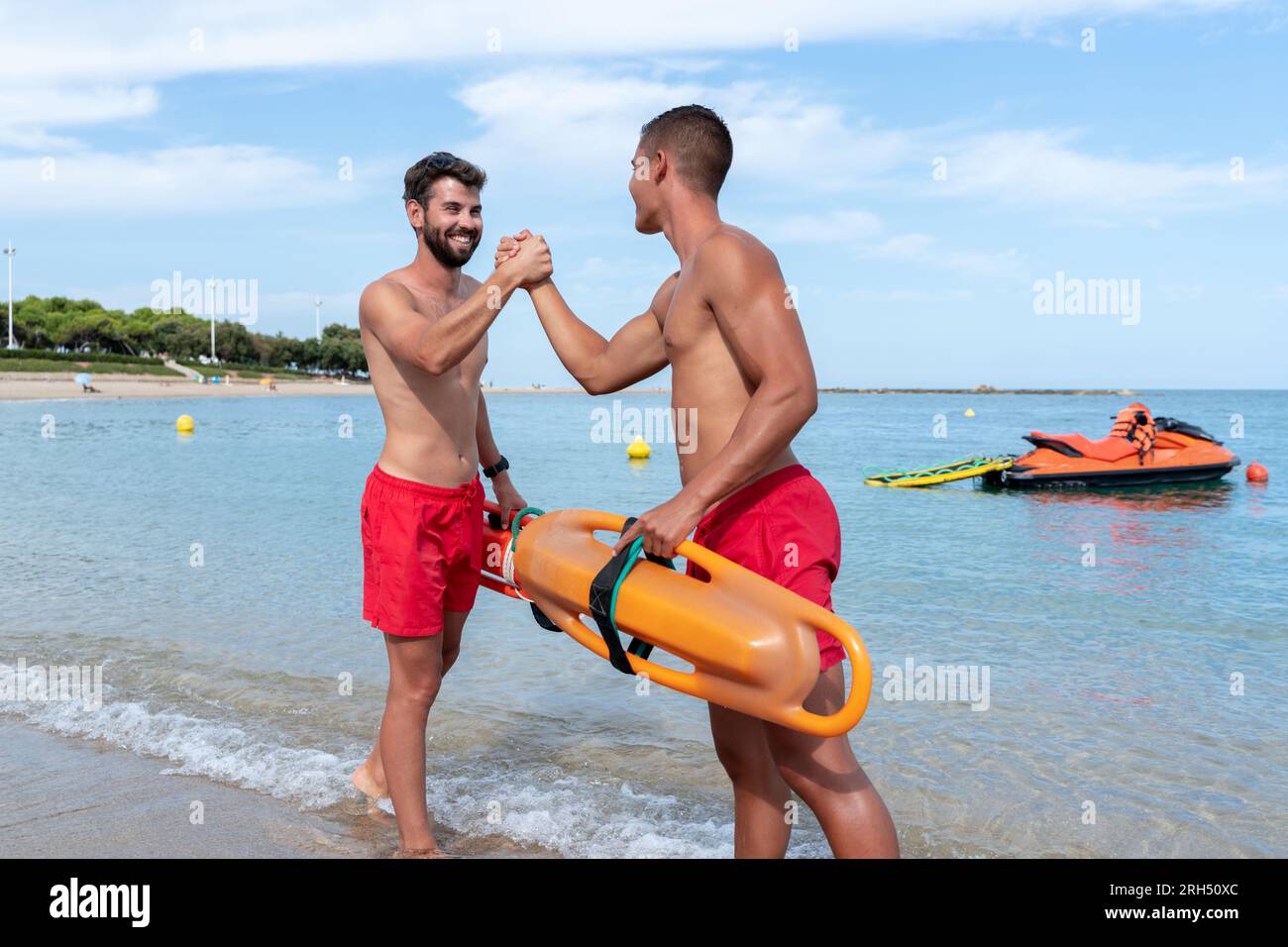 Photo with copy space of a team of lifeguards shaking hands Stock Photo ...