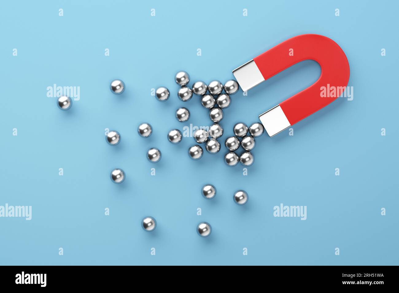 Metal spheres gravitated towards a red magnet on blue background ...