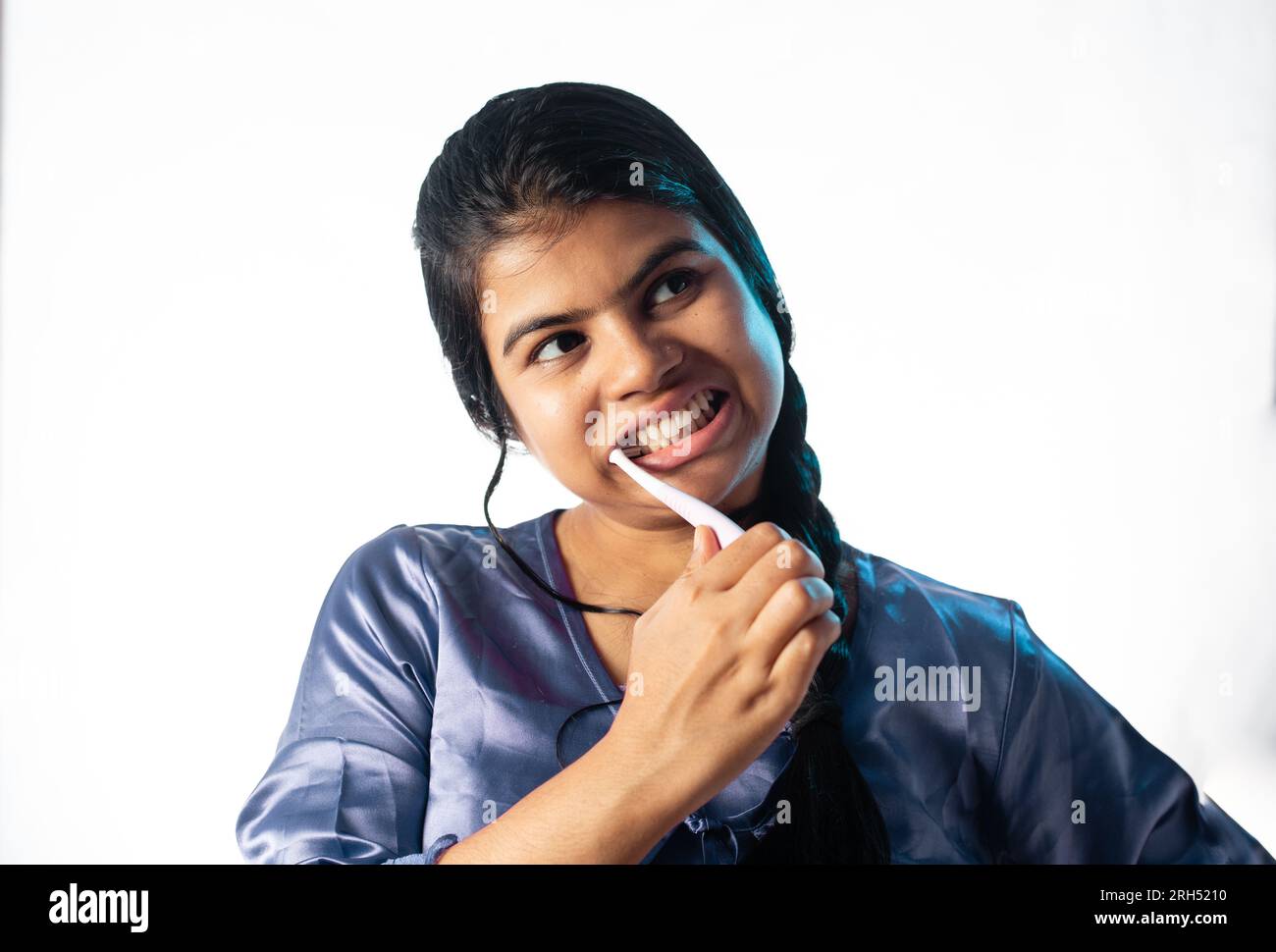 An Indian woman female girl brushing teeth on white background and ...
