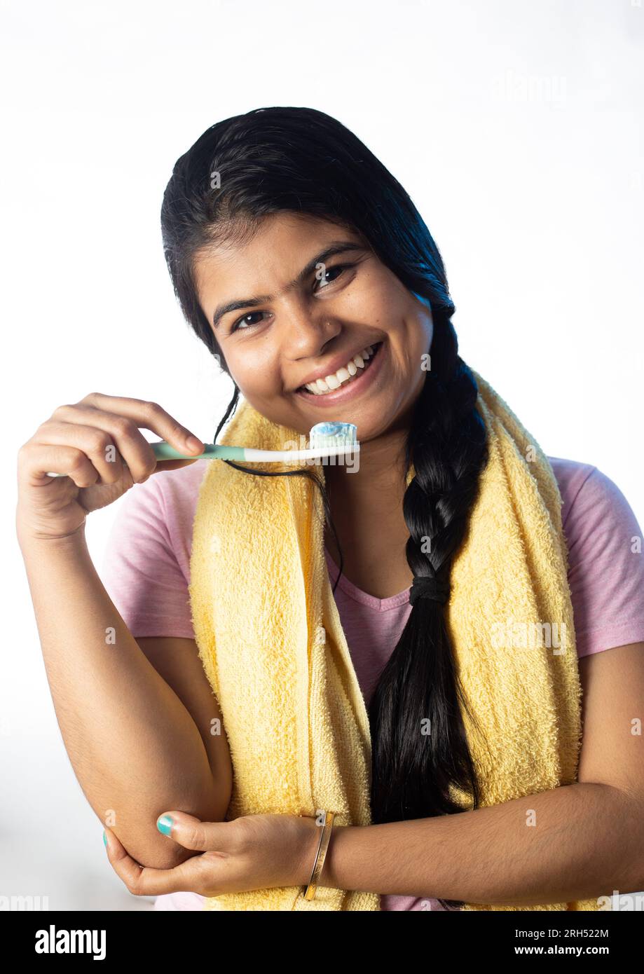 An Indian woman female girl brushing teeth on white background with ...