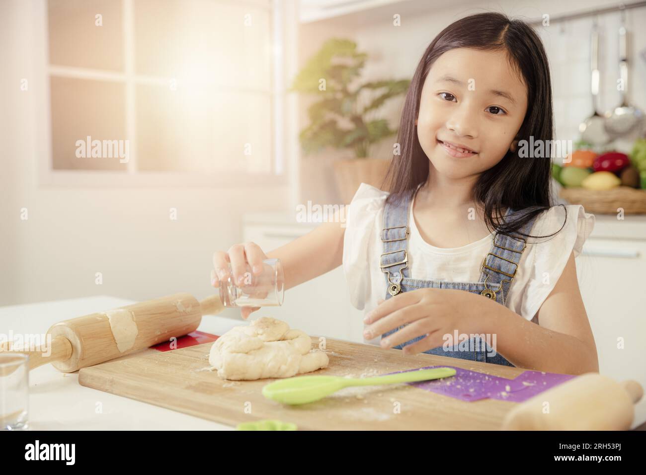 child girl portrait happy smiling playing cooking bakery food at home ...
